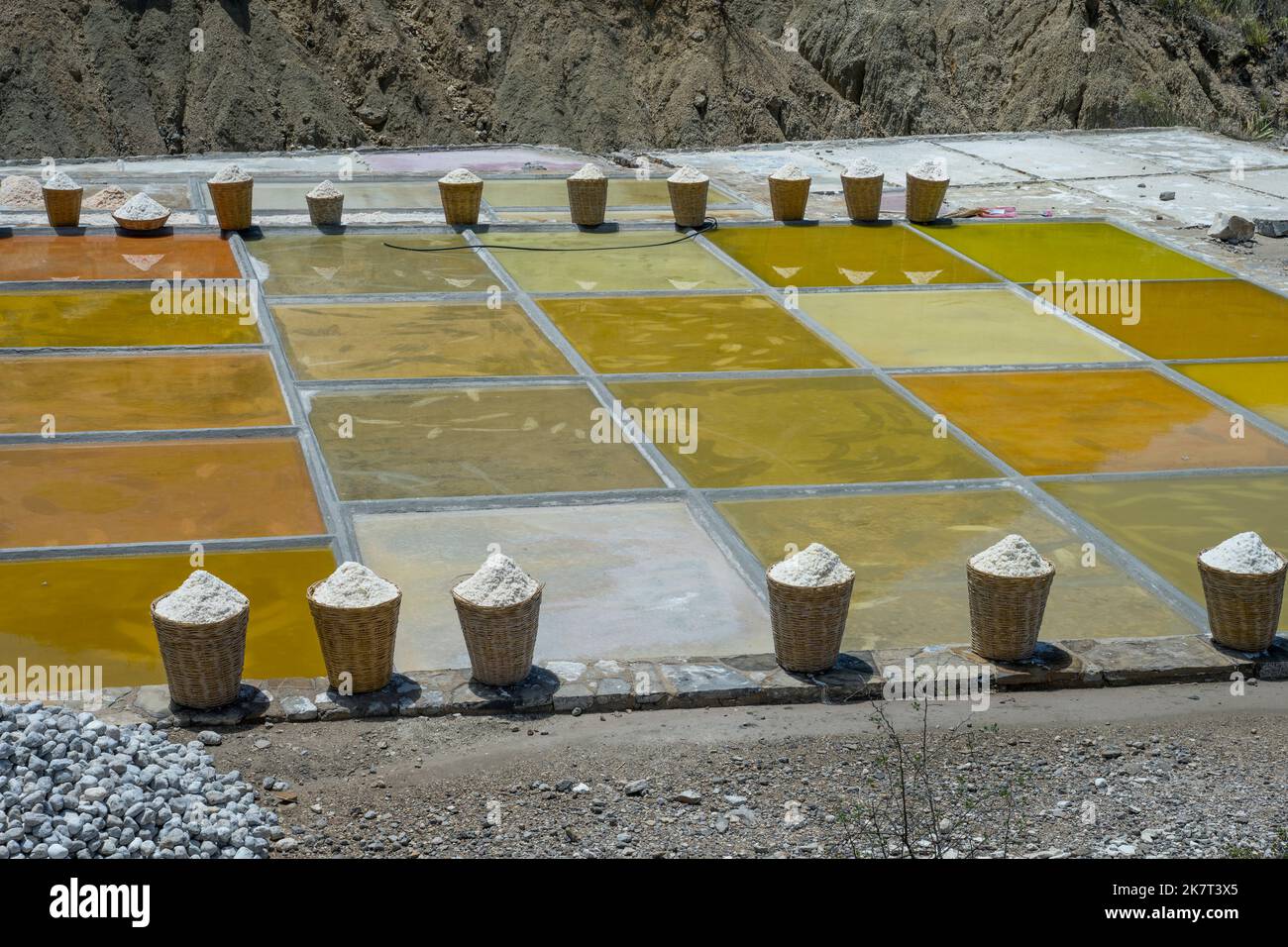 View of the saline pools and baskets of drying salt at a salt mining ...