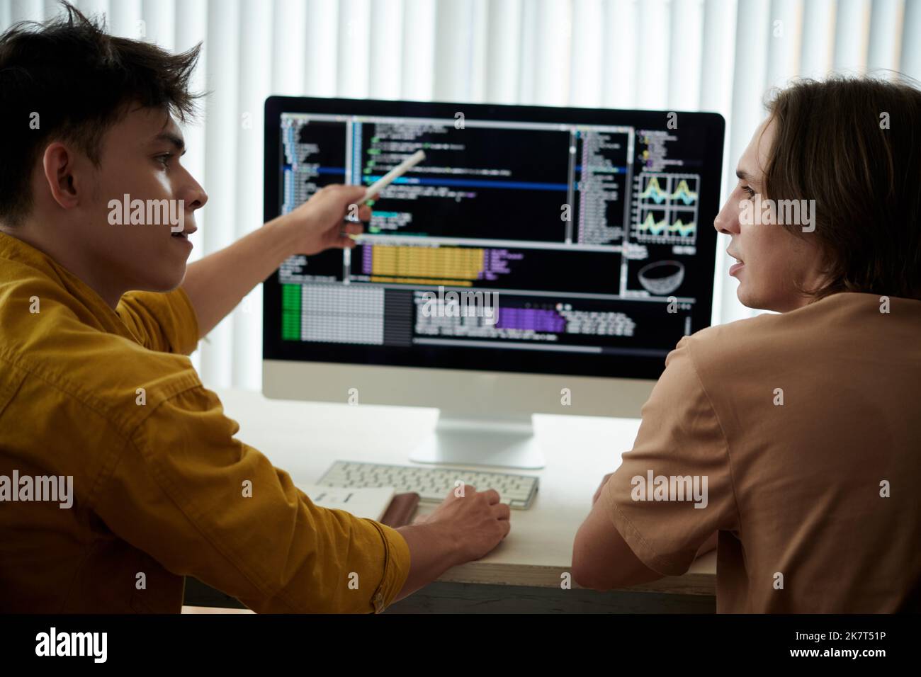 College students discussing programming code on computer screen Stock Photo - Alamy