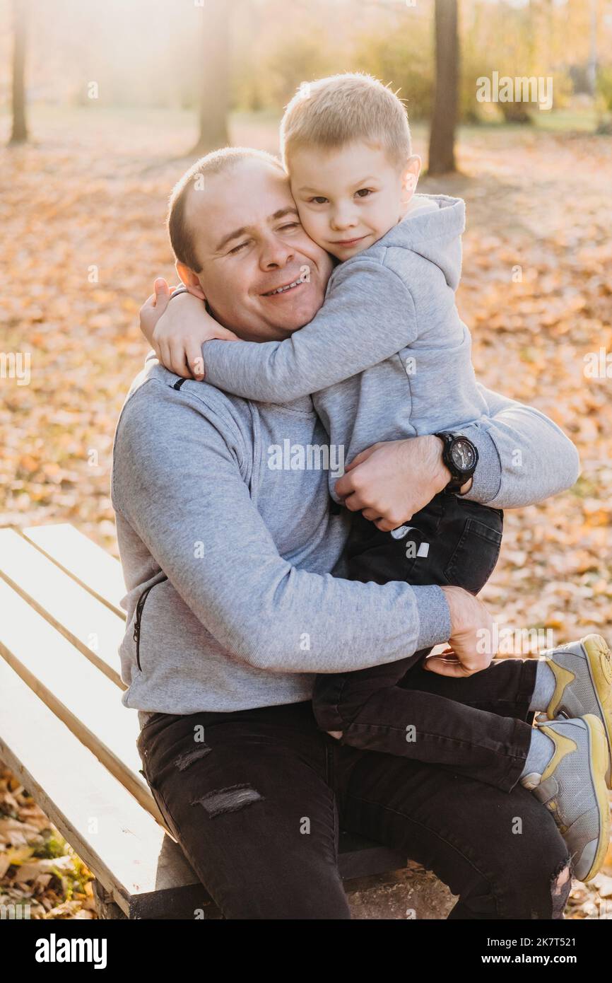Portrait of a happy family: father and child boy in the autumn leaf ...