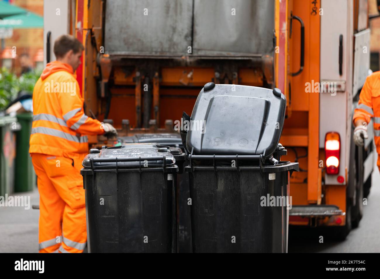 Picture of a garbage truck collecting waste in a big city Stock Photo ...
