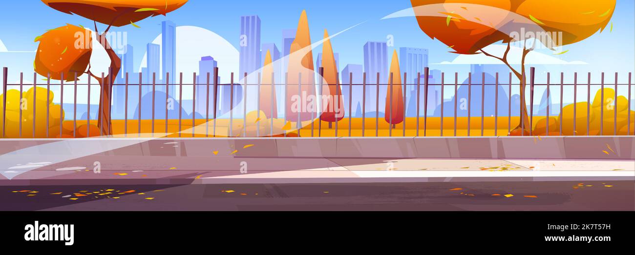 Autumn park behind metal fence, road with sidewalk and city skyscrapers ...