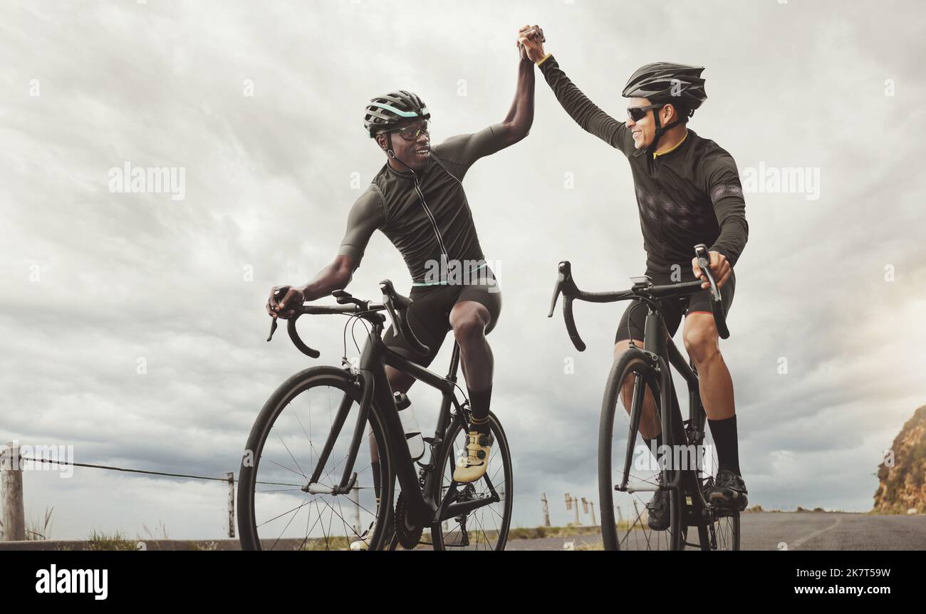 Cycling, friends and high five by men training, cycling and exercising ...