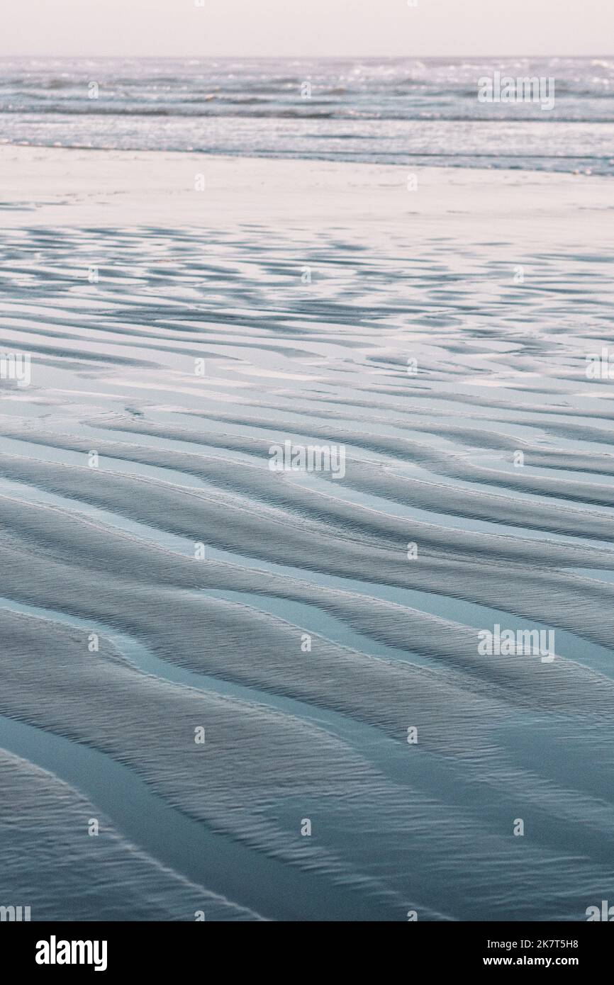 Blue waves of sand make an abstract pattern on a Pacific Ocean beach ...