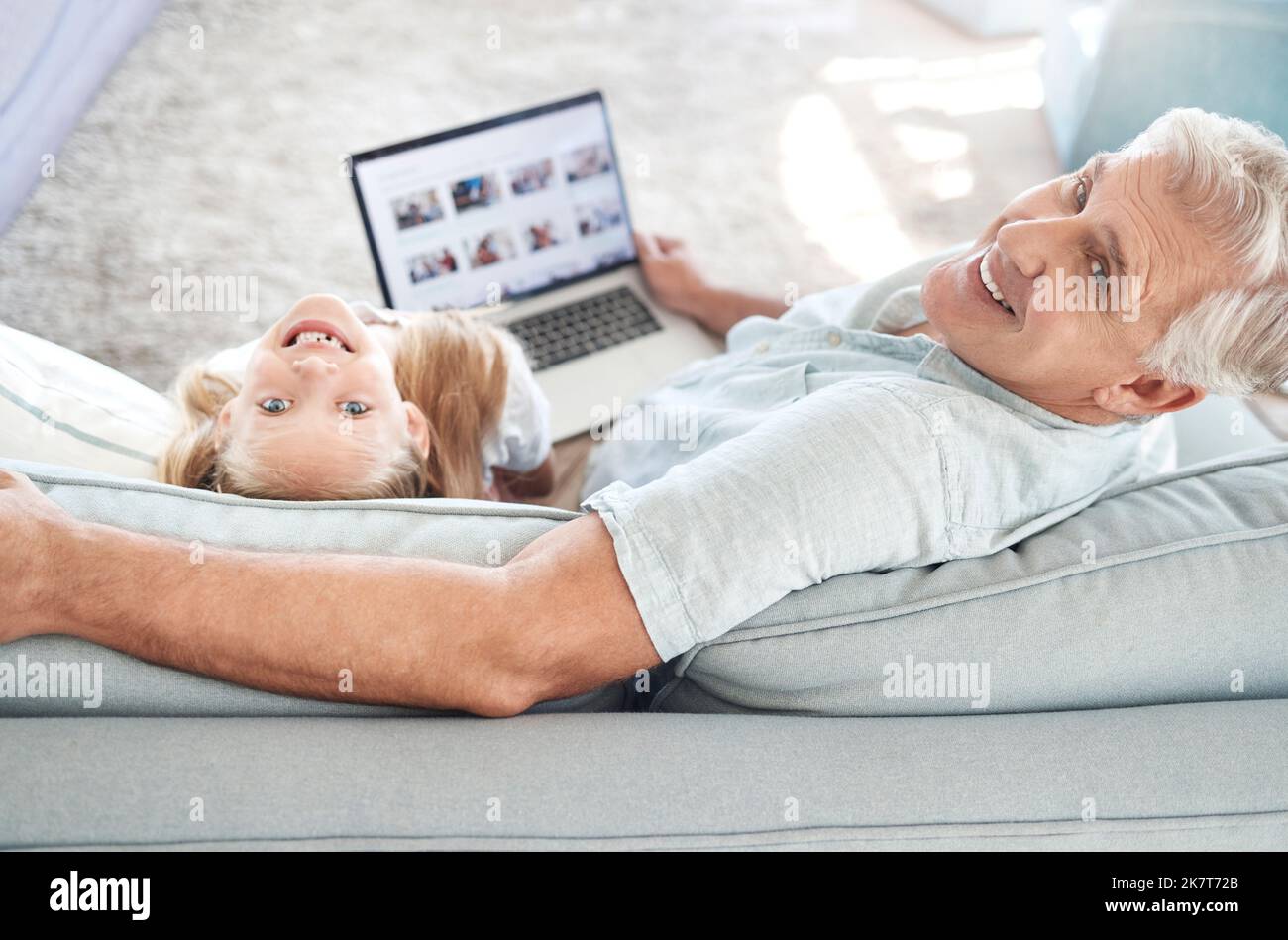 Portrait of relax grandfather, child and laptop with digital photo ...