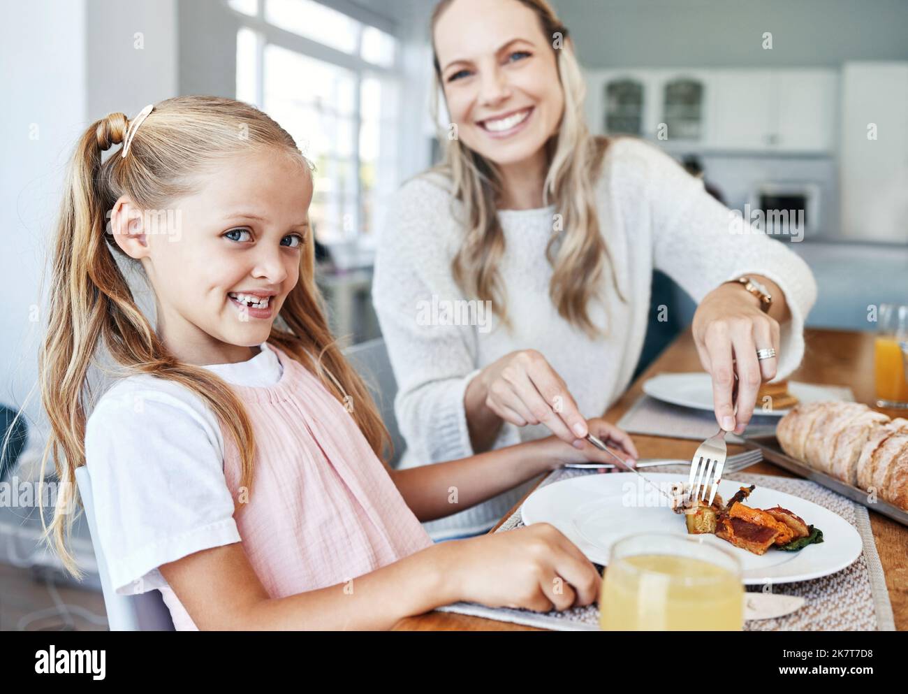 Two children sharing food table hi-res stock photography and images - Alamy