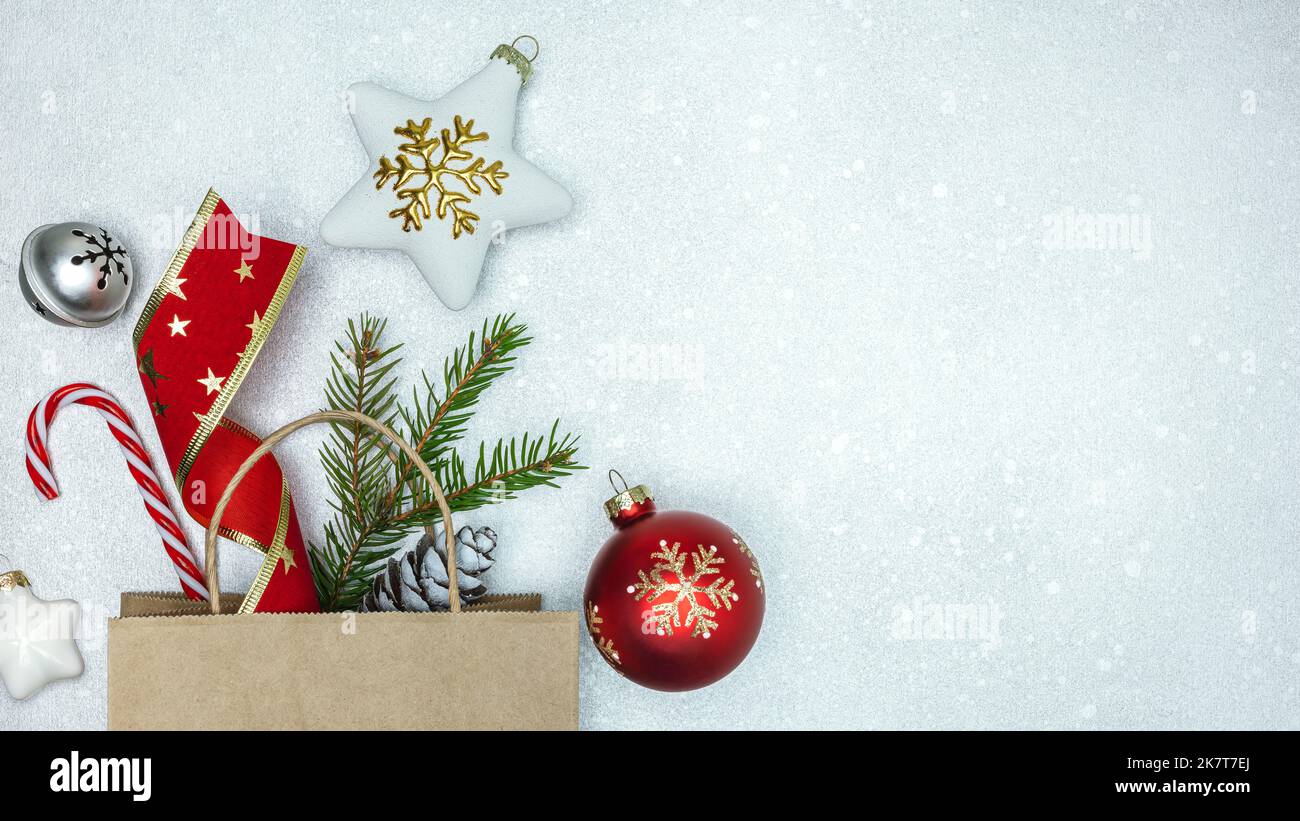 christmas shopping bag with fir branches, ornaments and baubles on ...