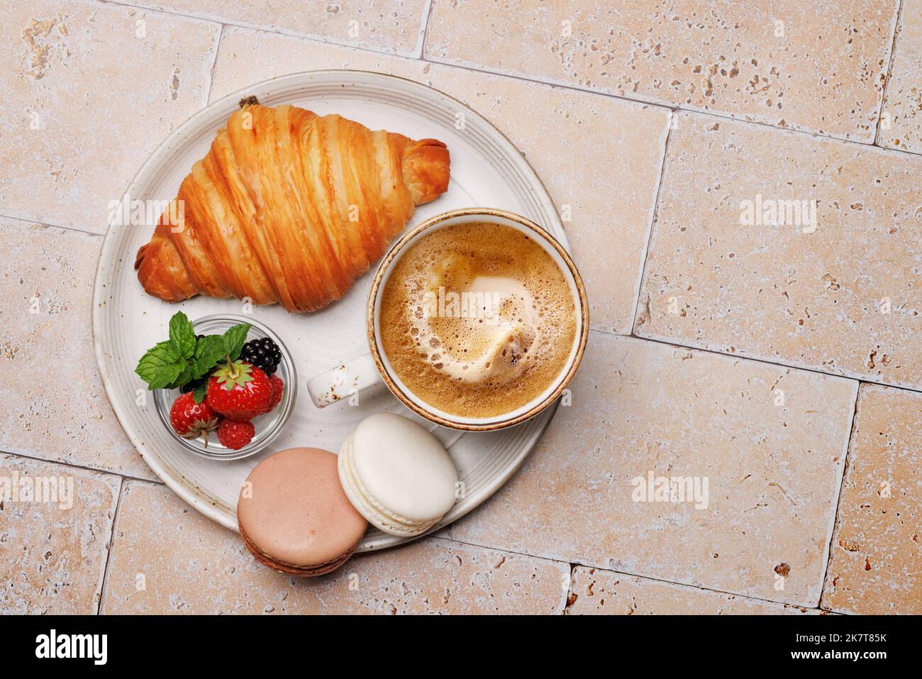 Coffee cup, macaroons, berries and croissant. Flat lay with copy space ...