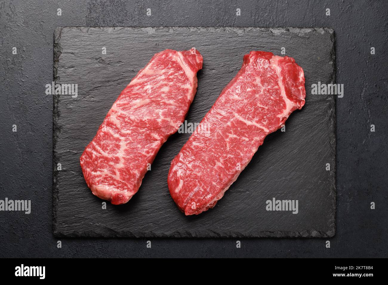 Prime marbled beef steaks. Raw striploin steak. Flat lay Stock Photo ...