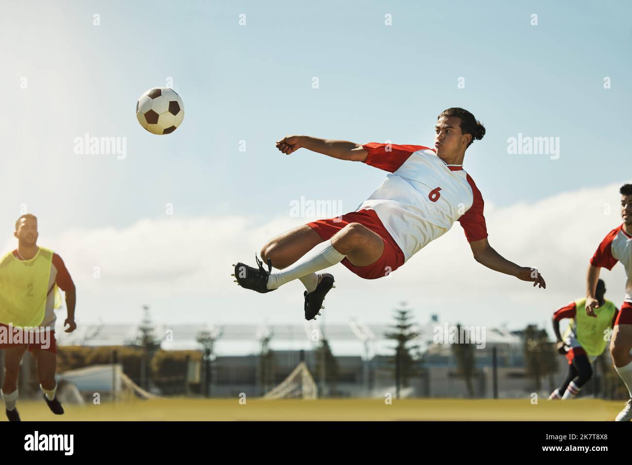 Soccer, game and man kicking a ball during training with the team on a ...