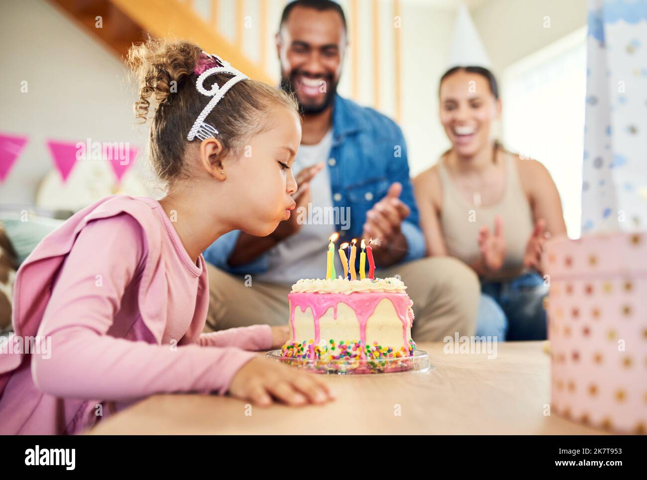 Dont forget to make a wish. a little girl celebrating a birthday with ...