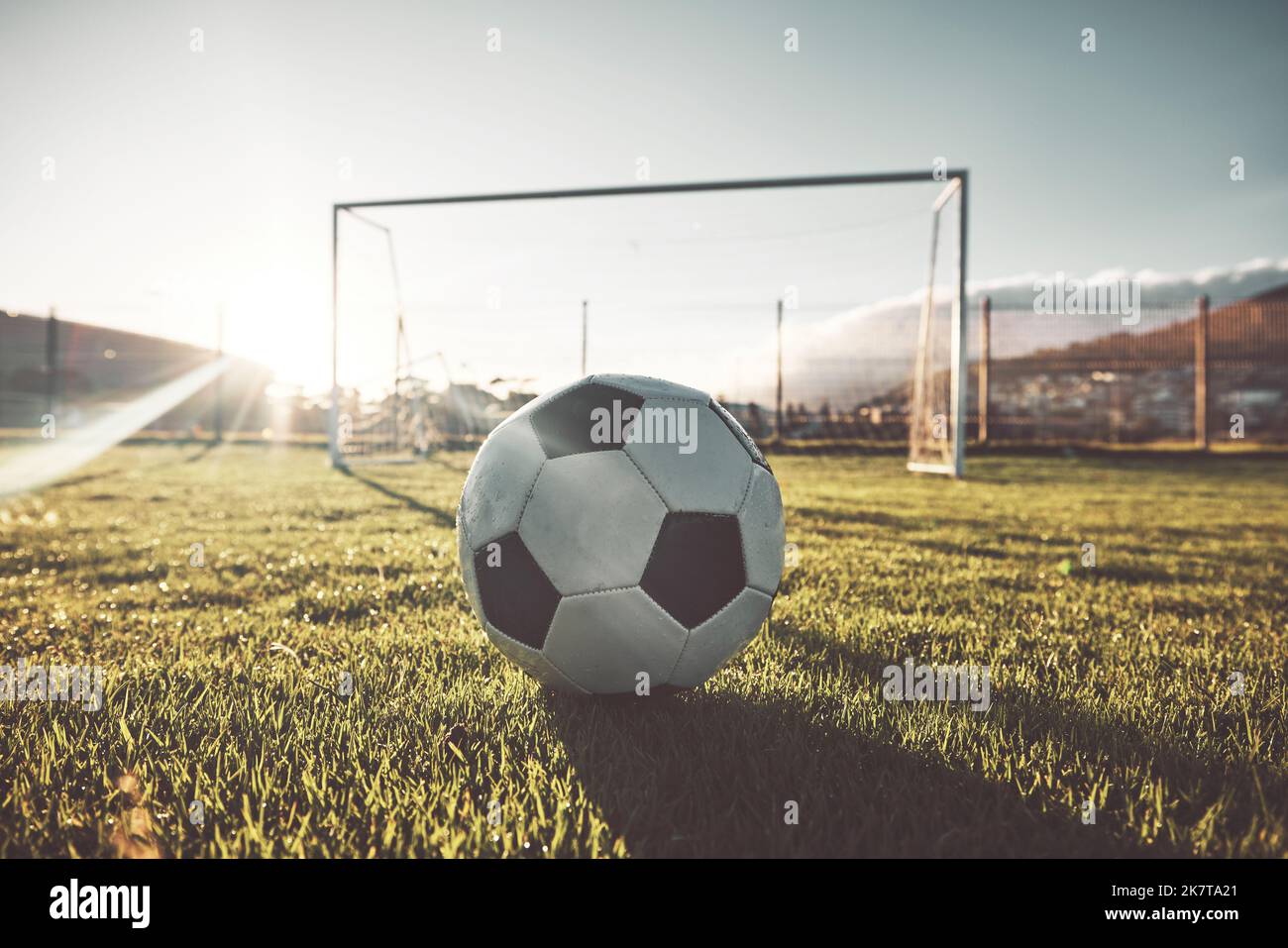 Soccer ball, goal post and grass on sports field, wellness club or ...