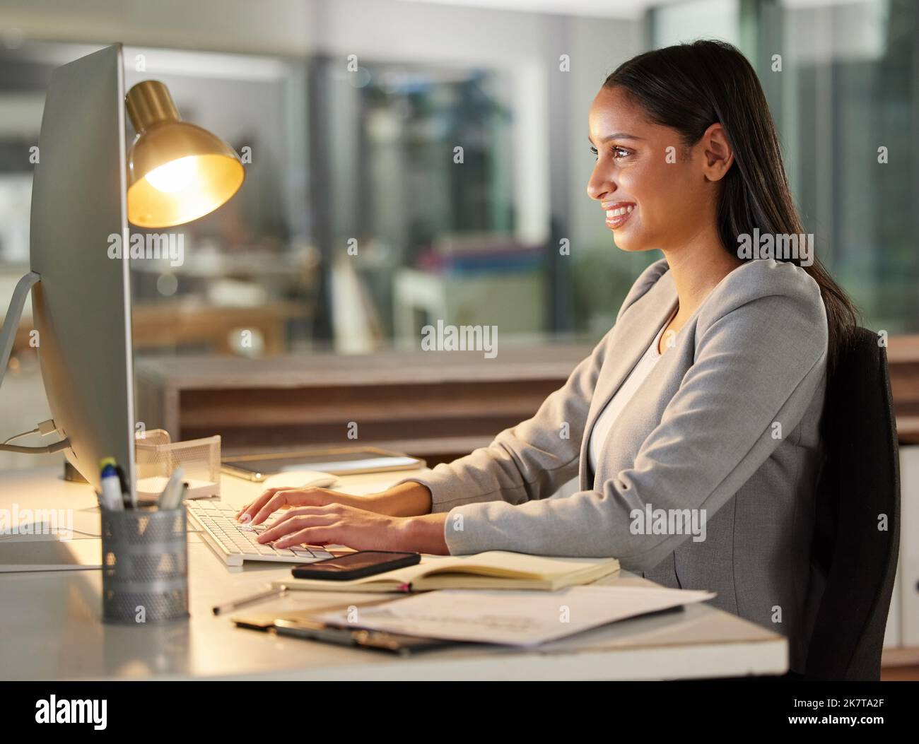 I will not be beaten by a deadline. a young businesswoman using a ...