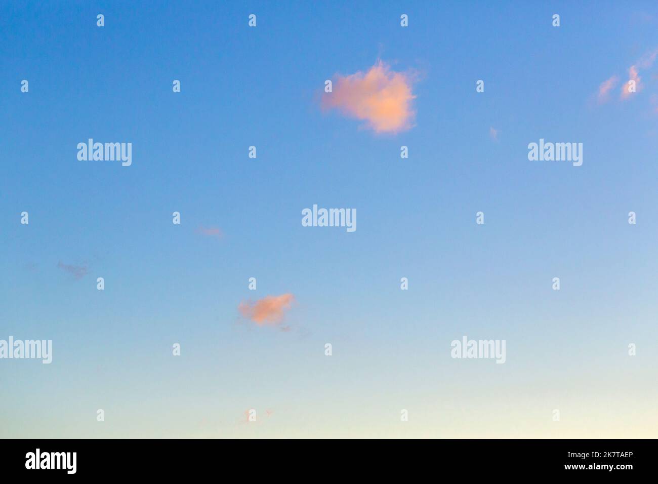 Lonely clouds on the blue sky with a strip of clouds at sunset Stock ...