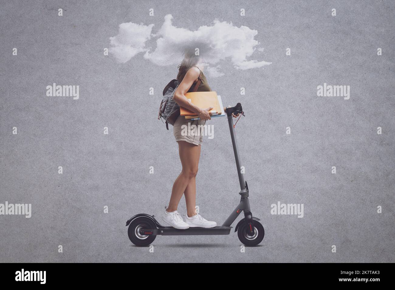 Distracted isolated student with head in a cloud riding a scooter Stock ...
