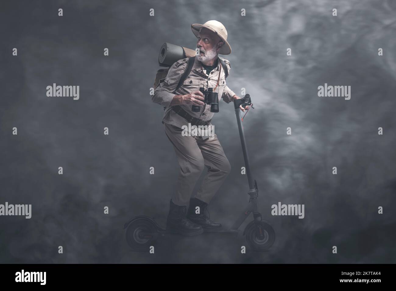 Scared explorer riding an electric scooter, he is surrounded by toxic ...