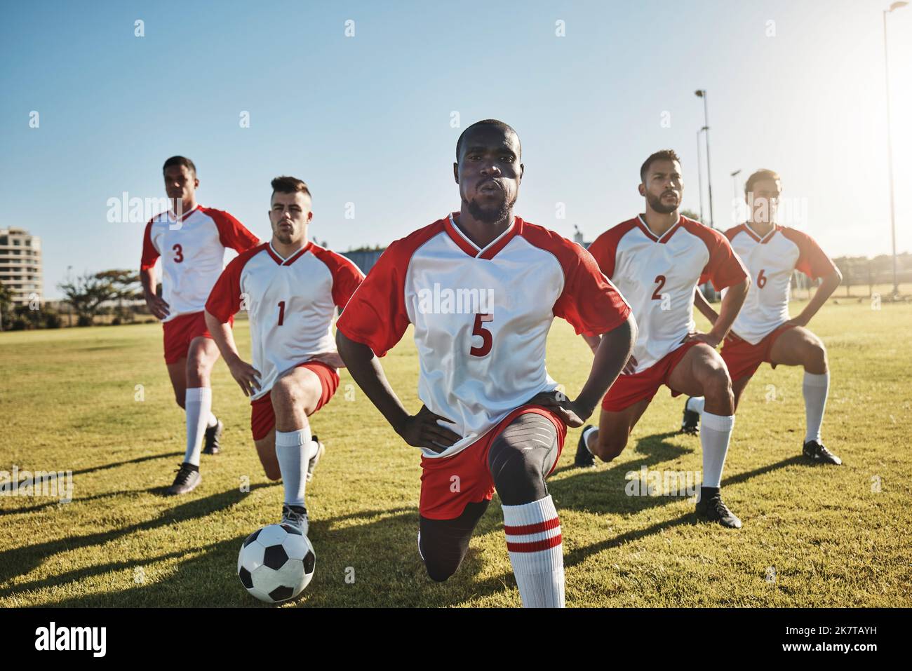 Soccer, men and team stretching on field before sports game or training ...