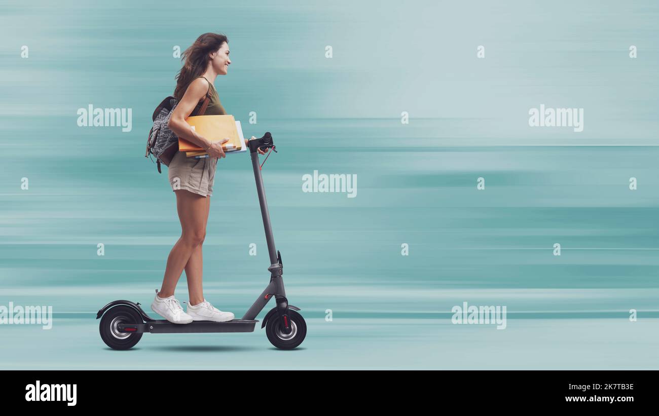 Happy young student riding a fast eco-friendly electric scooter, smart ...