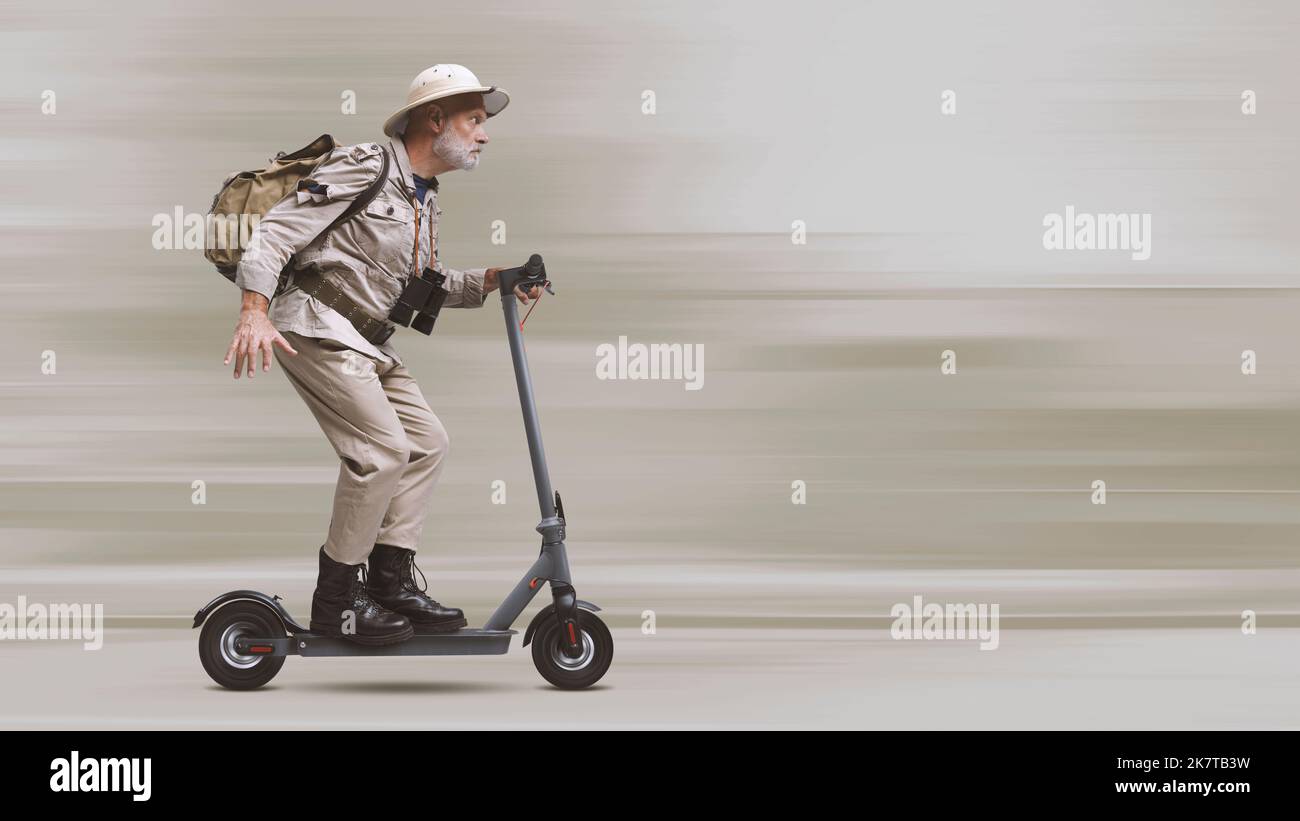 Funny explorer tourist travelling and riding a fast electric scooter ...