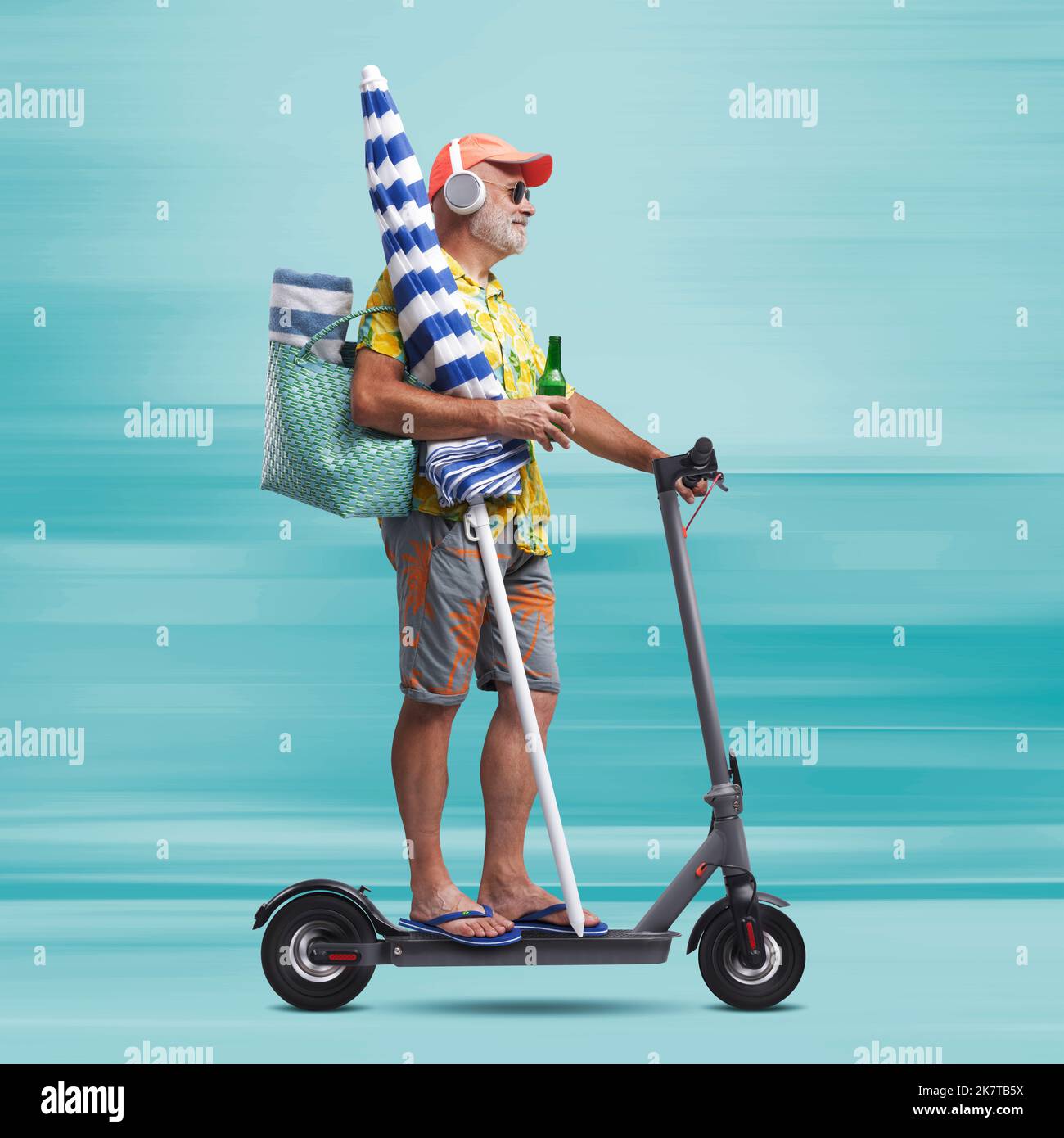 Funny happy senior tourist going to the beach, he is holding a beach ...