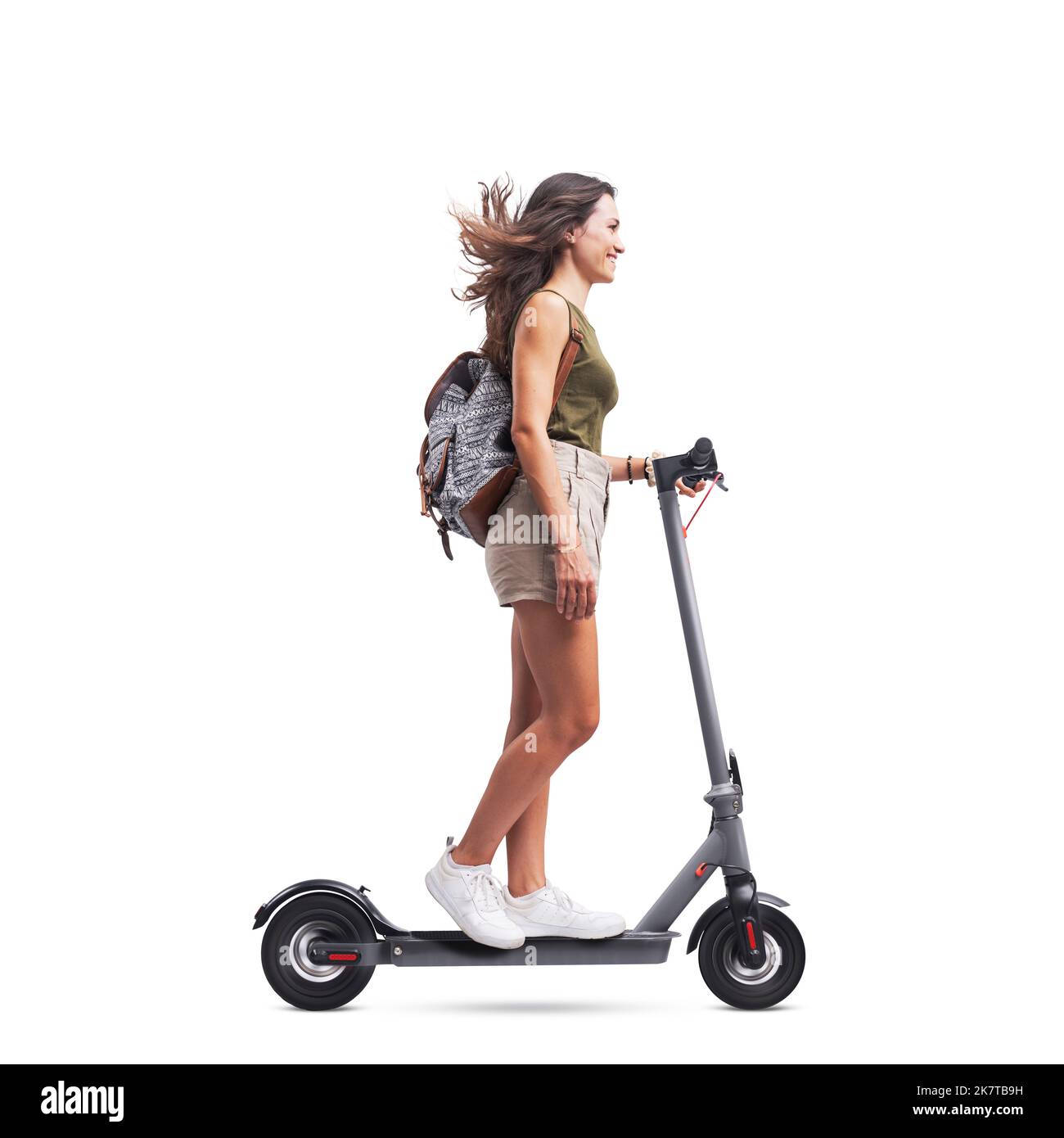 Smiling student with backpack riding an eco-friendly electric scooter ...