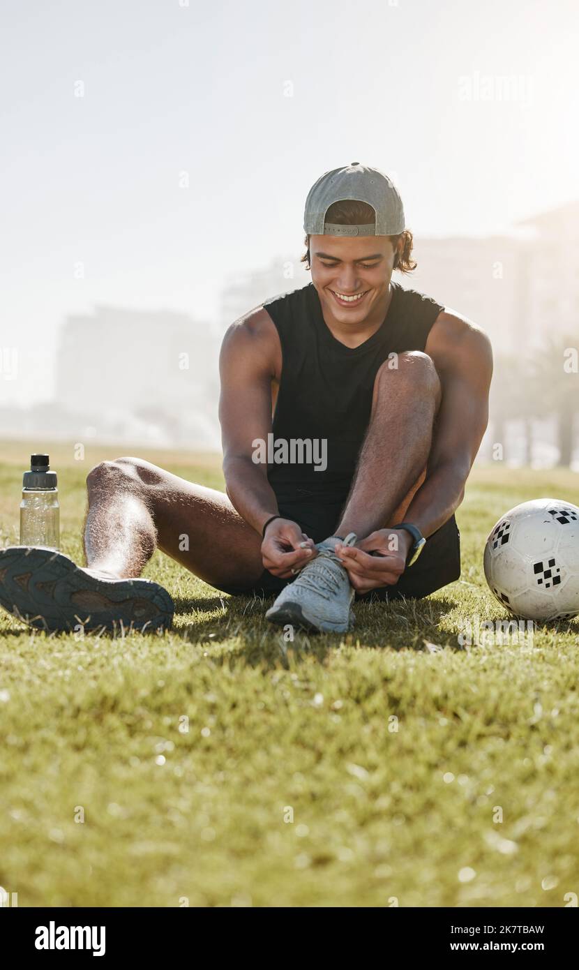 Fitness, grass and man tie shoes on grass for football training ...