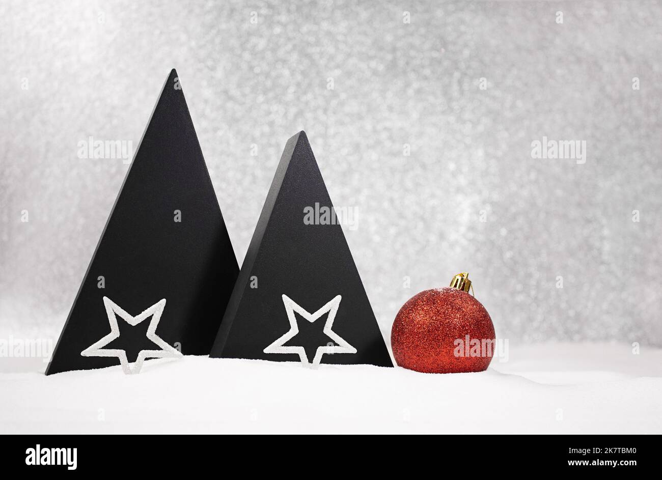 Black triangles of Christmas tree with white stars and red shiny ball ...