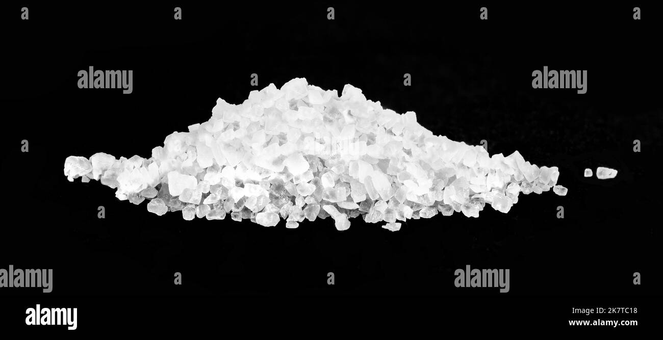 A heap of sea salt on black background Stock Photo - Alamy
