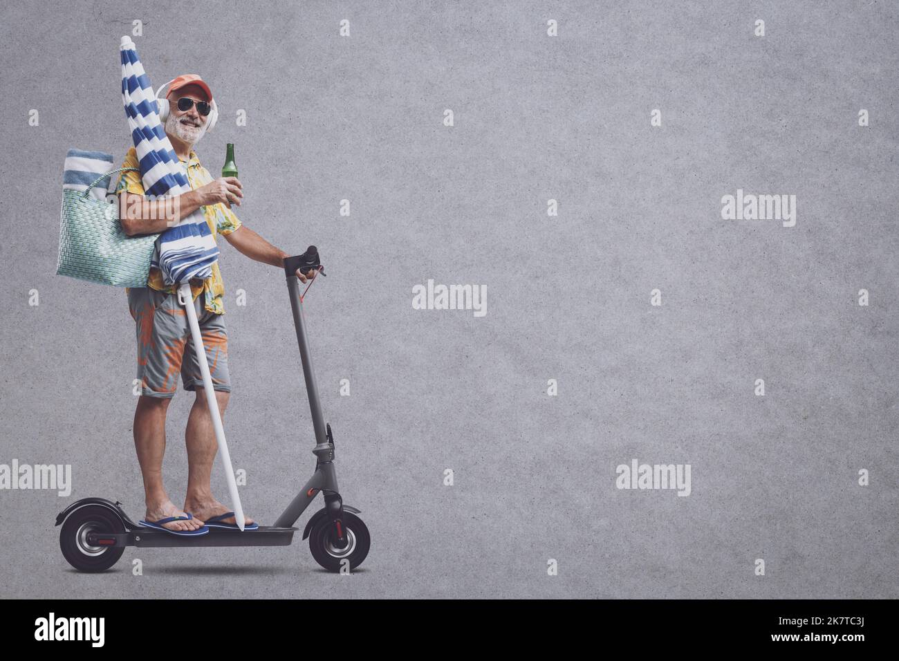 Happy senior tourist going to the beach on his fast electric scooter ...