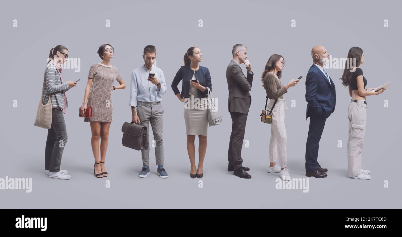 Diverse people standing and waiting patiently in line, isolated on gray ...