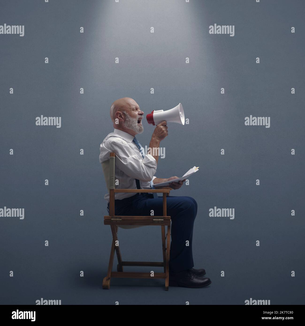 Film director sitting and shouting with a megaphone: film industry and ...