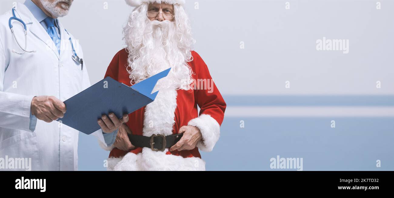 Santa Claus meeting a doctor at the hospital, healthcare and prevention ...