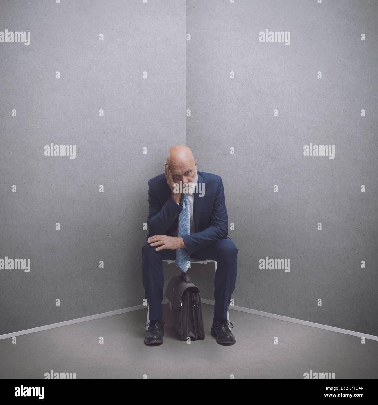 Senior corporate businessman sitting in a corner, job interview and ...