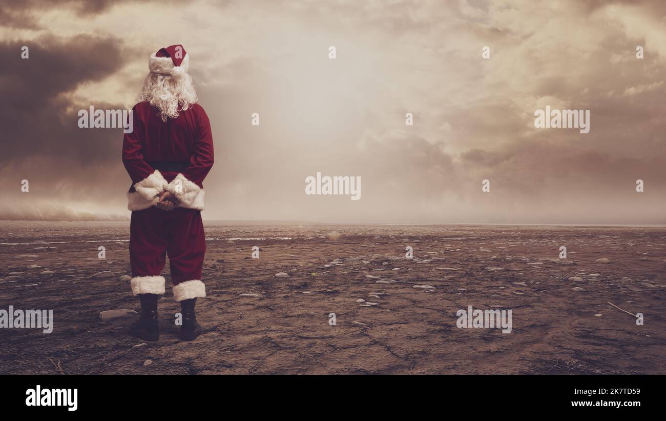 Hopeless lonely Santa Claus staring at the barren polluted land in ...