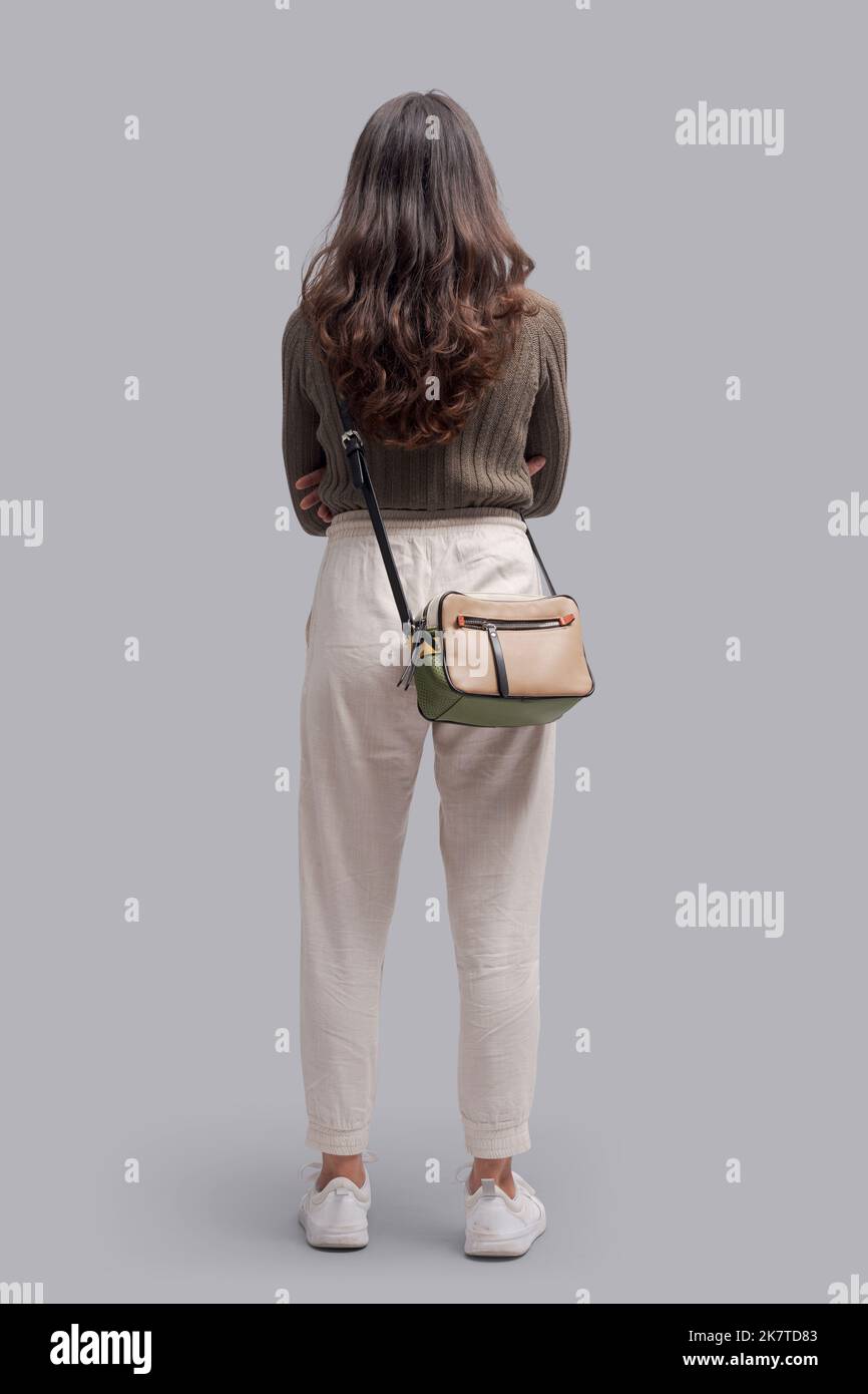 Young casual woman standing, back view, full-length portrait Stock ...