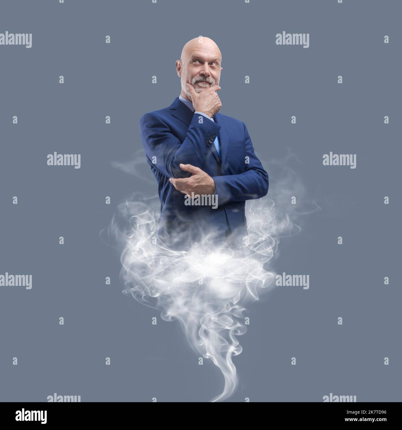 Businessman genie appearing and smoke, he is thinking with hand on chin ...