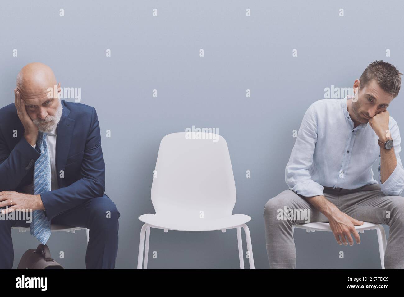 Bored job candidates sitting in the waiting room, they are waiting for ...