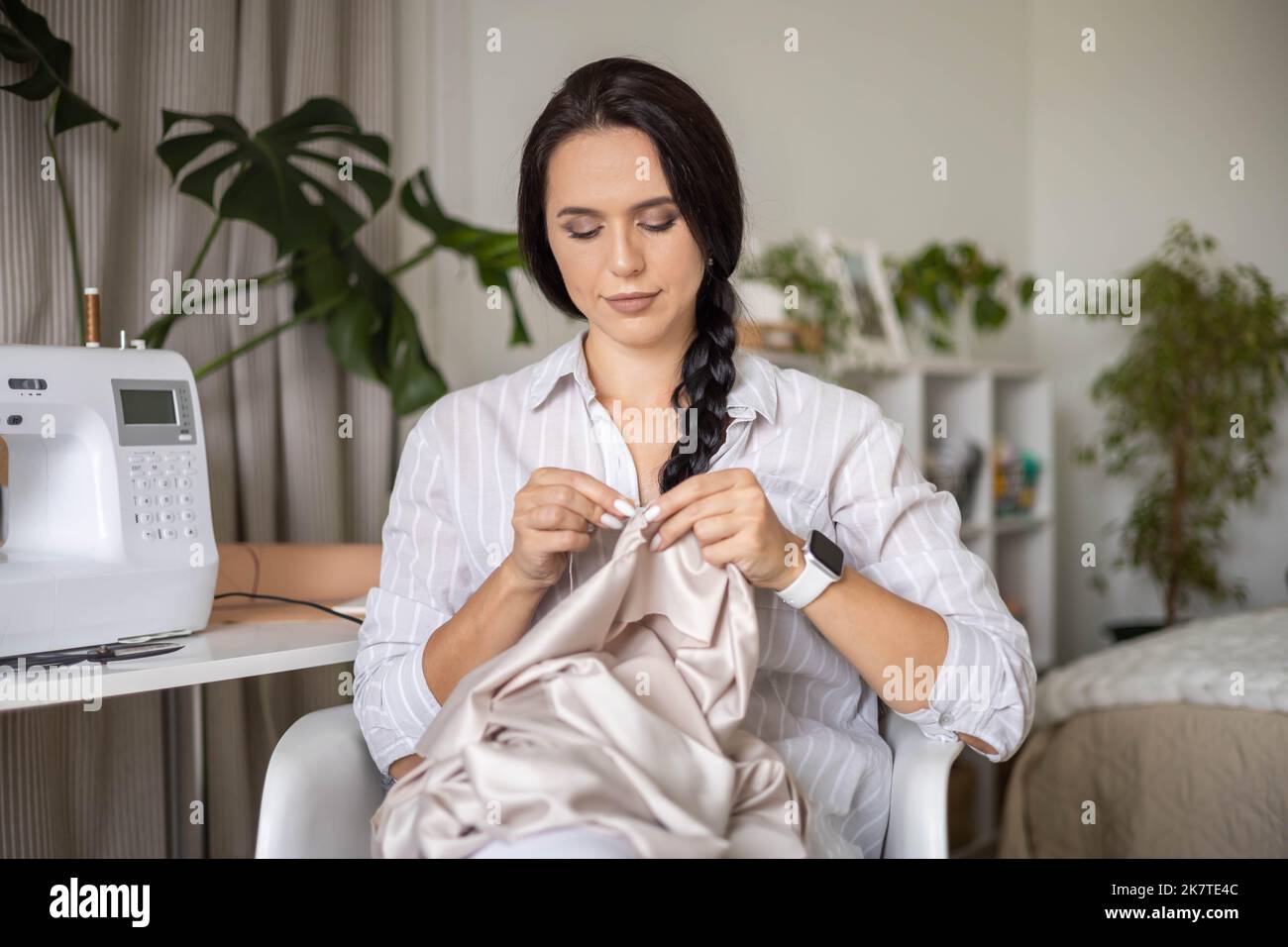 Beauty brunette woman tailor sew with needle thread enjoy art work ...