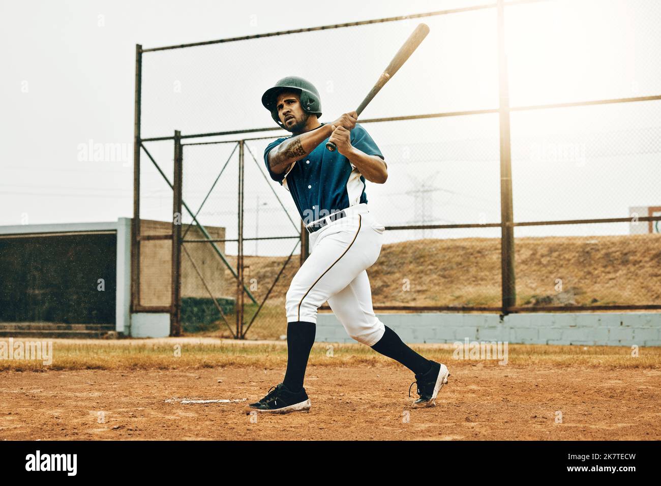 Baseball man, stadium game or hit ball with bat on a sport field in a ...