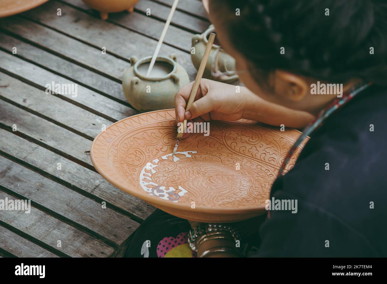 Artist paint sketch drawing traditional style pattern on dish ...