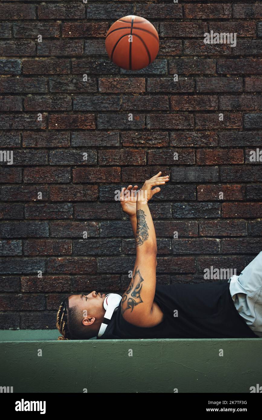 Sports ball, ground and relax basketball man on the floor, practice ...