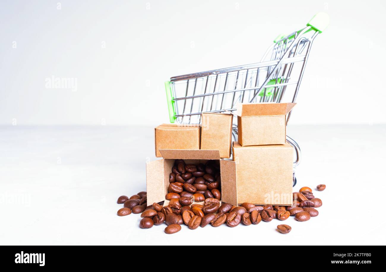 Miniature shopping trolley and tiny cardboard boxes full of roasted ...