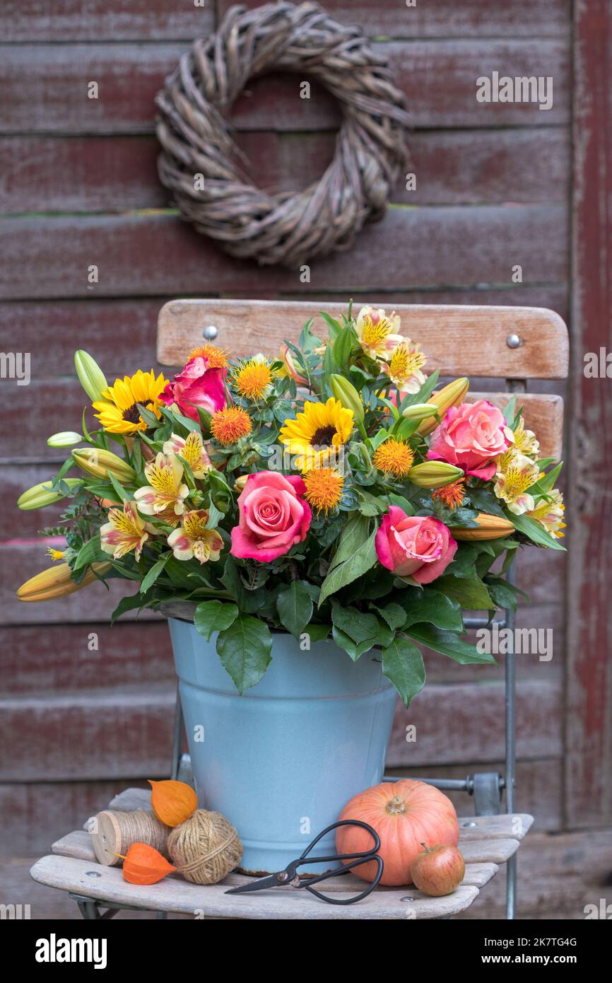 bouquet with pink roses, sunflowers, lily flowers and safflowers in ...