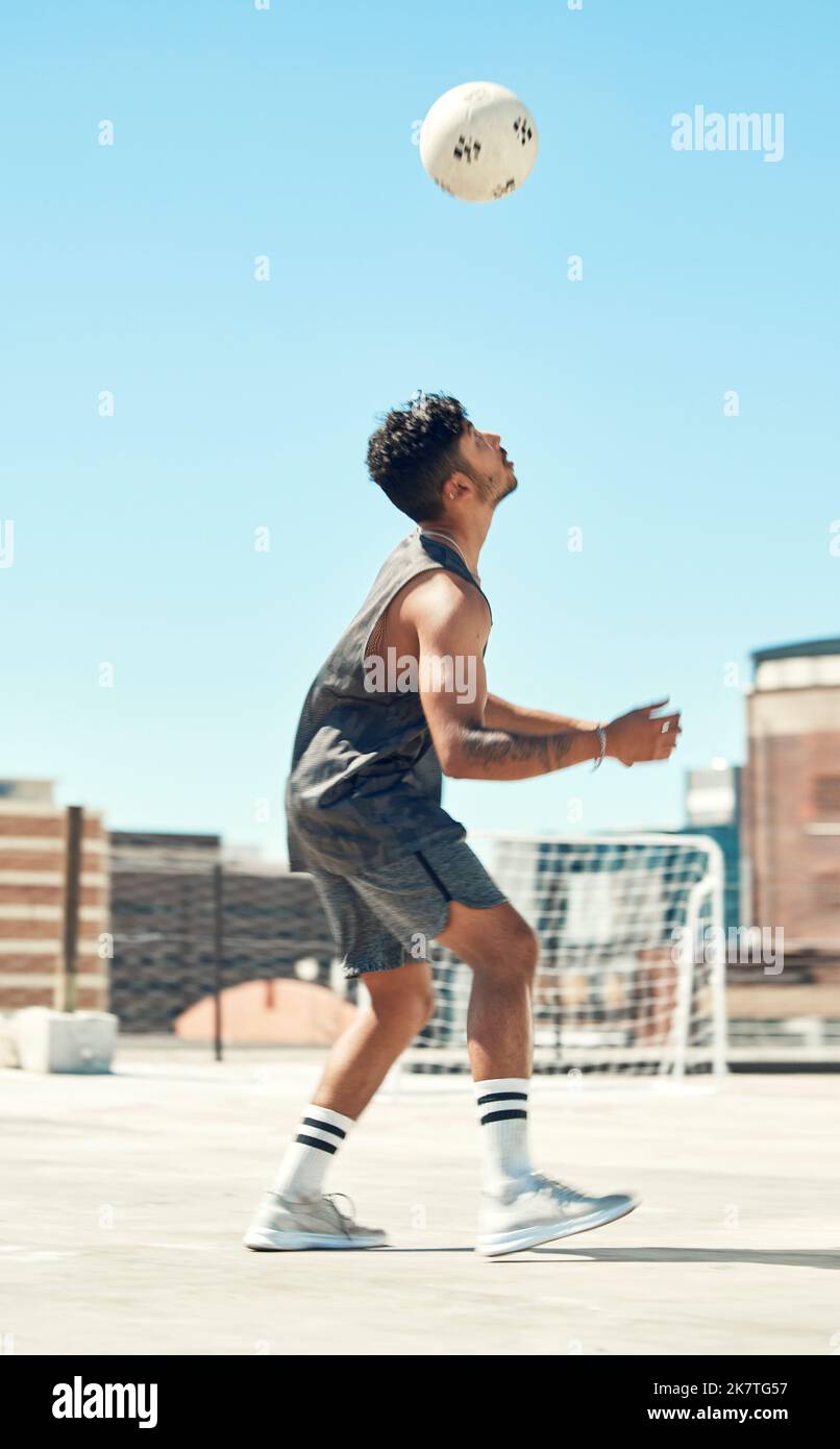 Training, soccer and man with ball in air trick on city rooftop in ...