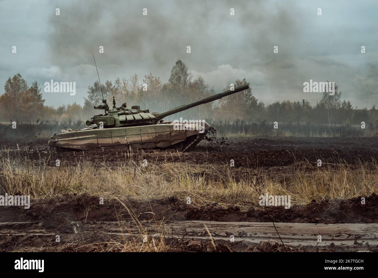 Heavy Military Tank on the battlefield at a hot spot. A tank moves ...