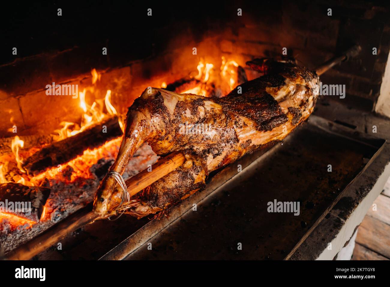The lamb is cooked entirely on a spit on the fire. Cooking Stock Photo ...