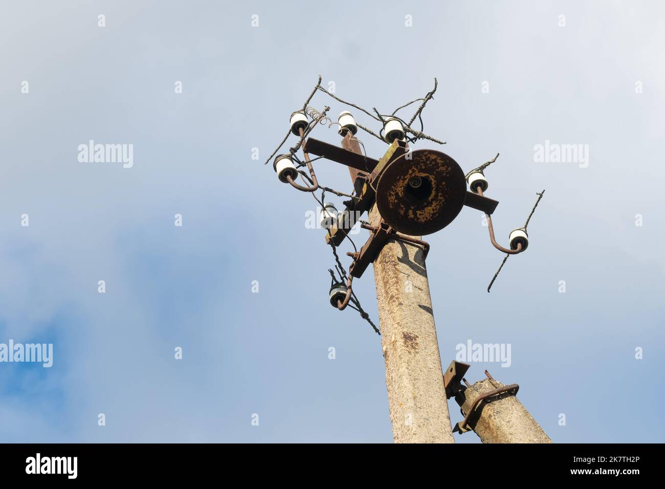 One old concrete street pole with a rusty iron part at the top and cut ...