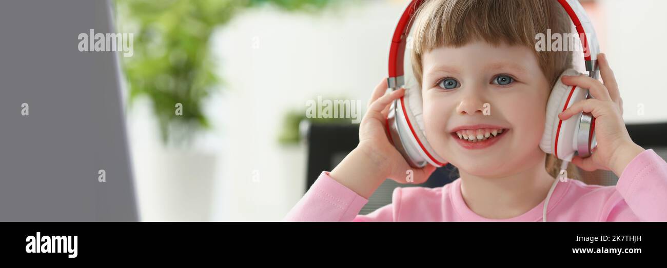 Little happy girl wearing headset, fun pastime for child on holiday ...