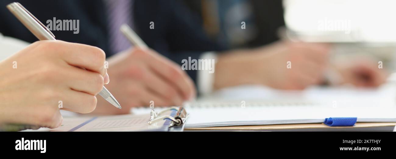 People on conference writing down ideas in diary, notes for project ...