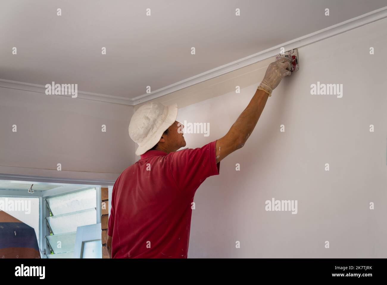 Man painting wall using paint edge roller. Home refurbishment do it ... Man painting wall using paint edge roller. Home refurbishment do it ...