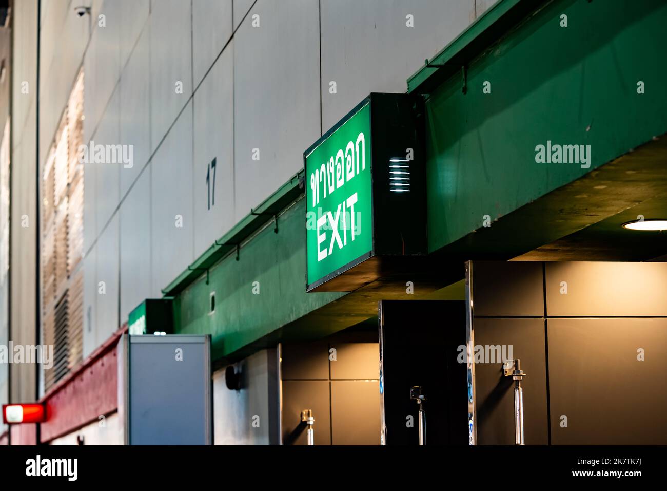 Large Emergency exit sign green light box is placed on the wall of ...